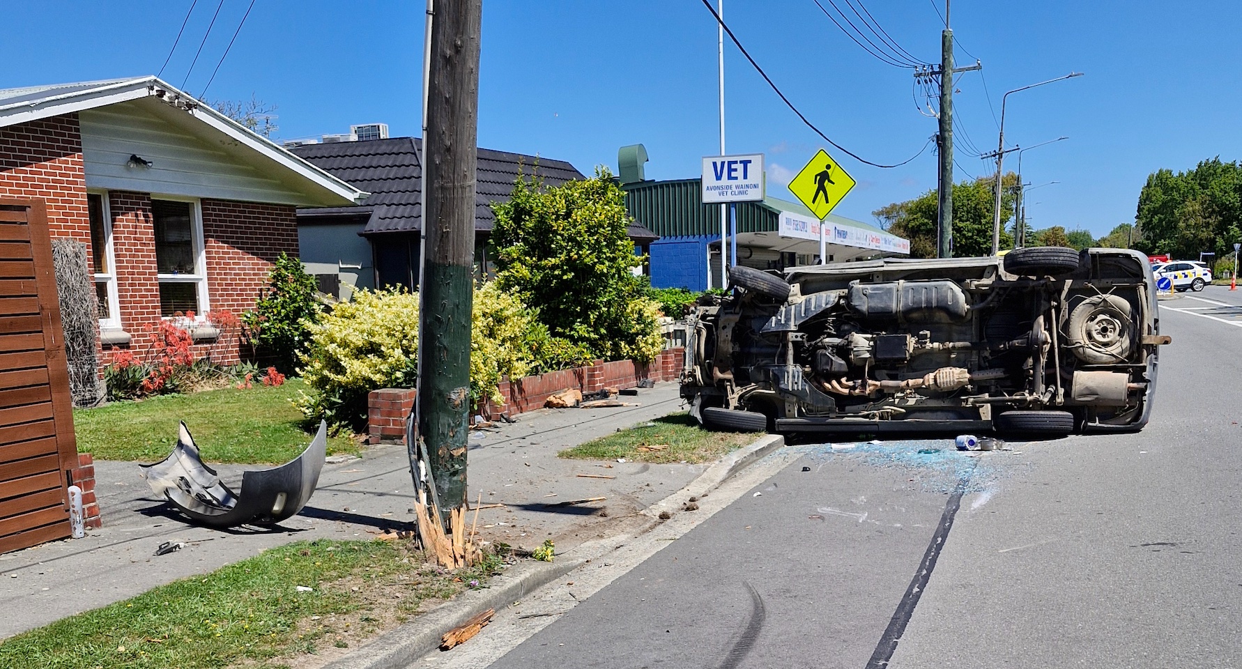 Vehicle flips in Wainoni Road crash, power pole damaged - Chris Lynch Media